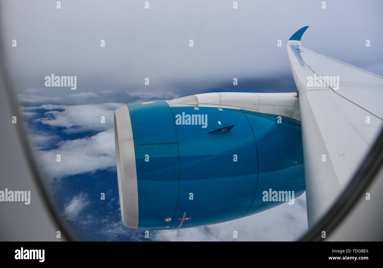 Blue engine of passenger airplane in the sky with cloudscape background ...