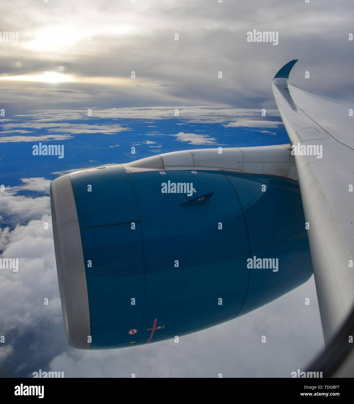 Blue engine of passenger airplane in the sky with cloudscape background ...