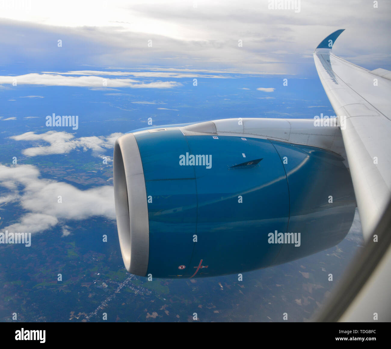 Blue engine of passenger airplane in the sky with cloudscape background ...