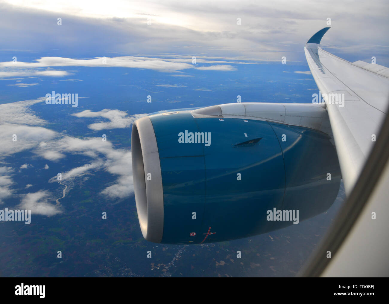 Blue engine of passenger airplane in the sky with cloudscape background ...
