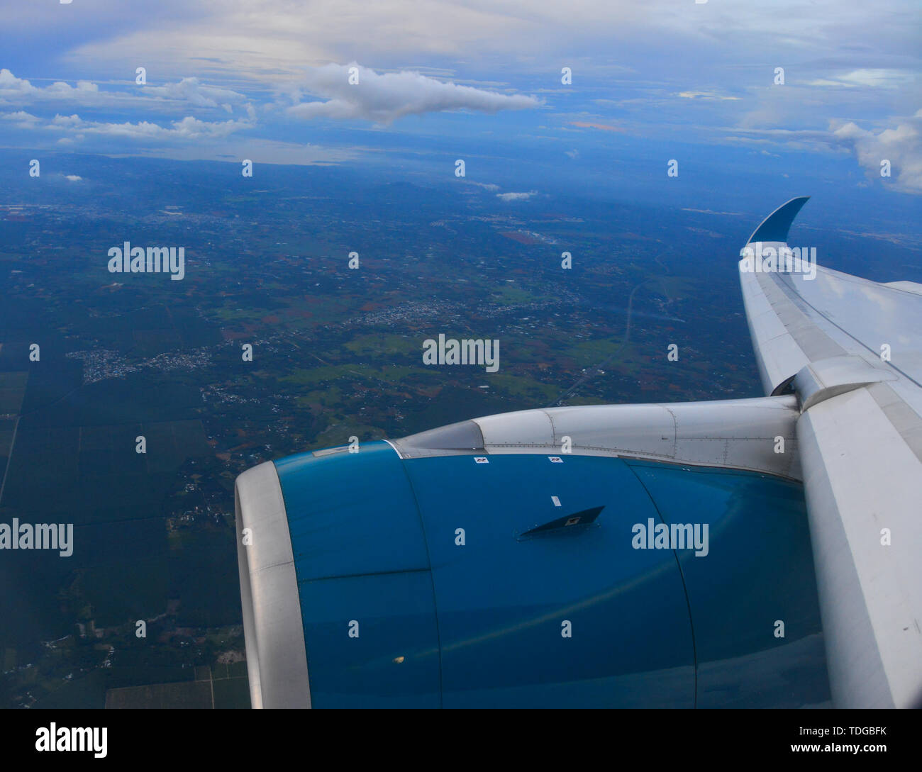 Blue engine of passenger airplane in the sky with cloudscape background ...