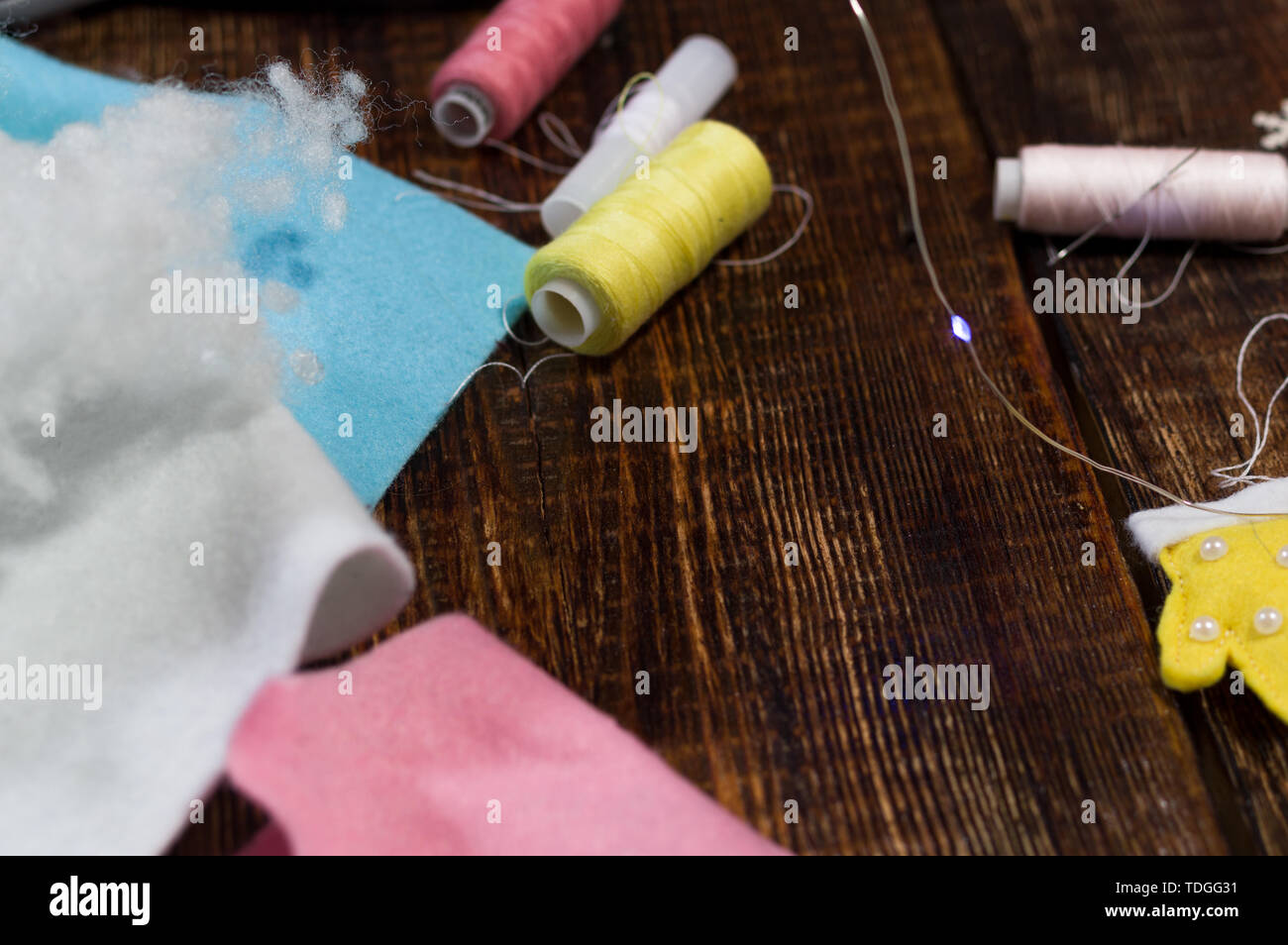 Multi-colored thread and fabric. Sewing materials. Coils of thread ...