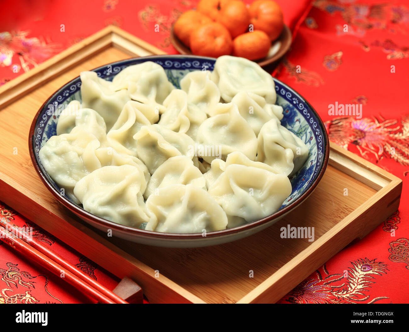 Spring Festival dumplings on red background Stock Photo - Alamy