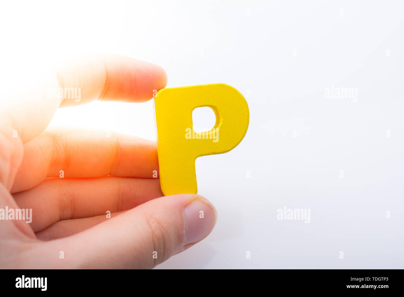 Hand holding letter cube P of made of wood Stock Photo - Alamy