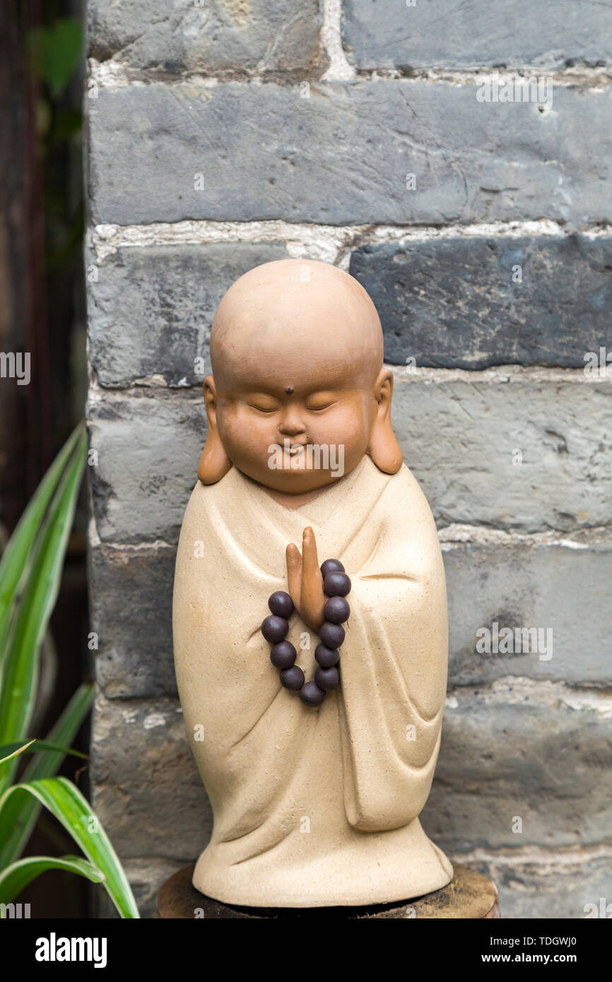 A statue of a little monk Stock Photo - Alamy
