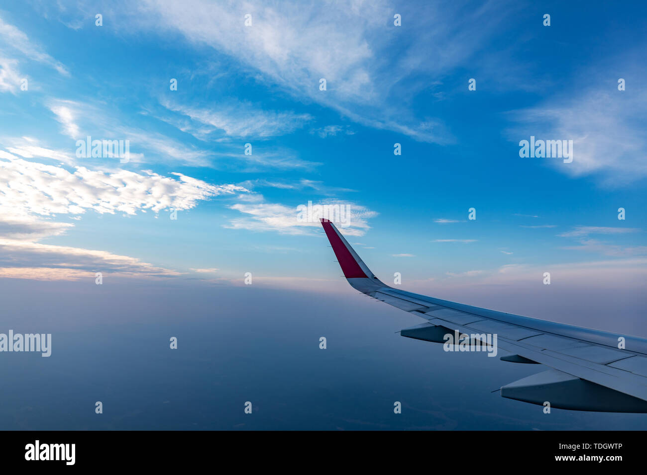 A view of the plane's flight over the clouds from the plane window ...
