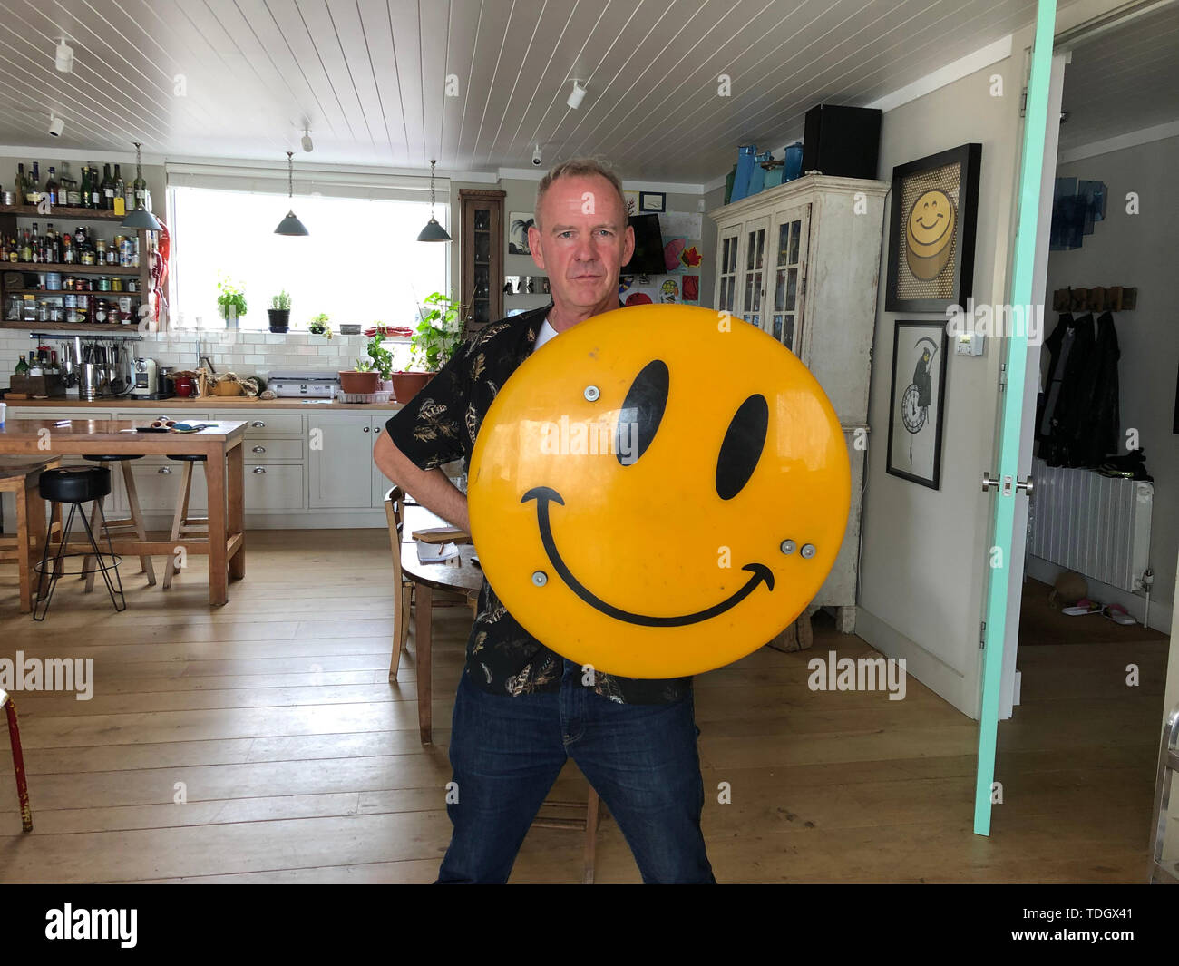 Embargoed to 0001 Monday June 17 Fatboy Slim holding a smiley face at ...