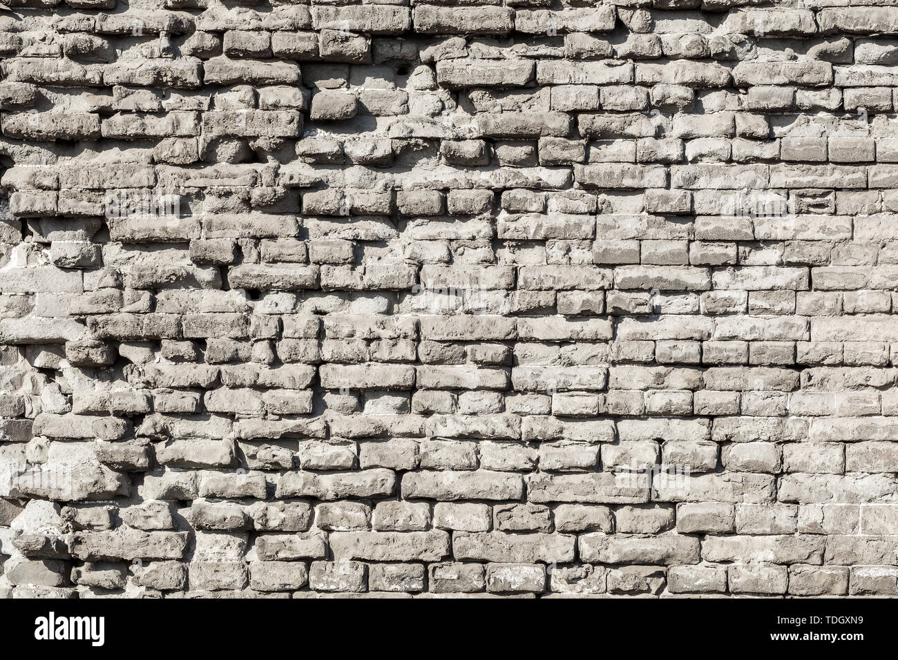 Gray old brick walls, mottled surfaces eroded by wind and rain ...