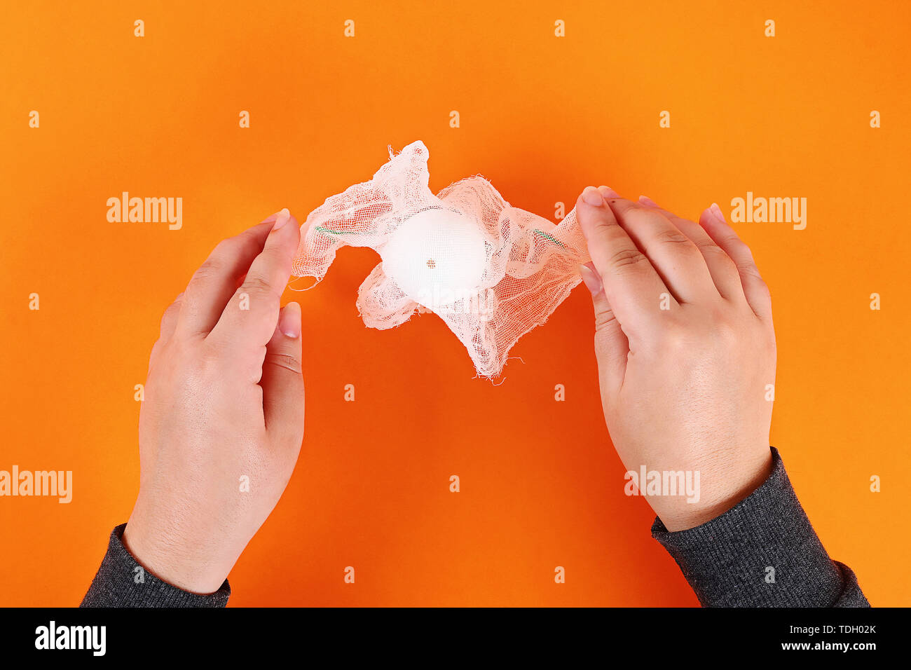 8 Diy Halloween ghost of starch and gauze on orange background. Gift ...