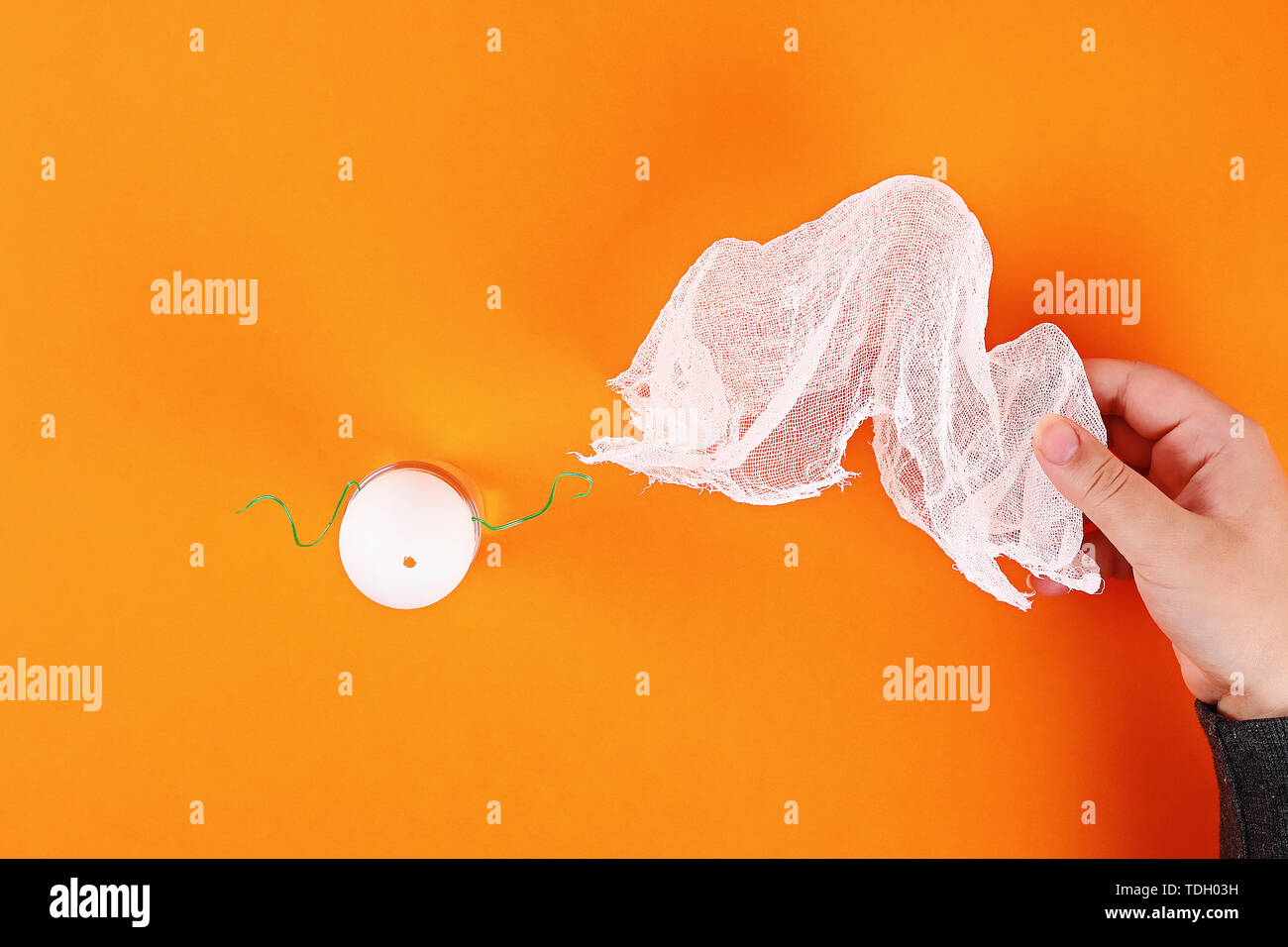 10 Diy Halloween ghost of starch and gauze on orange background. Gift ...
