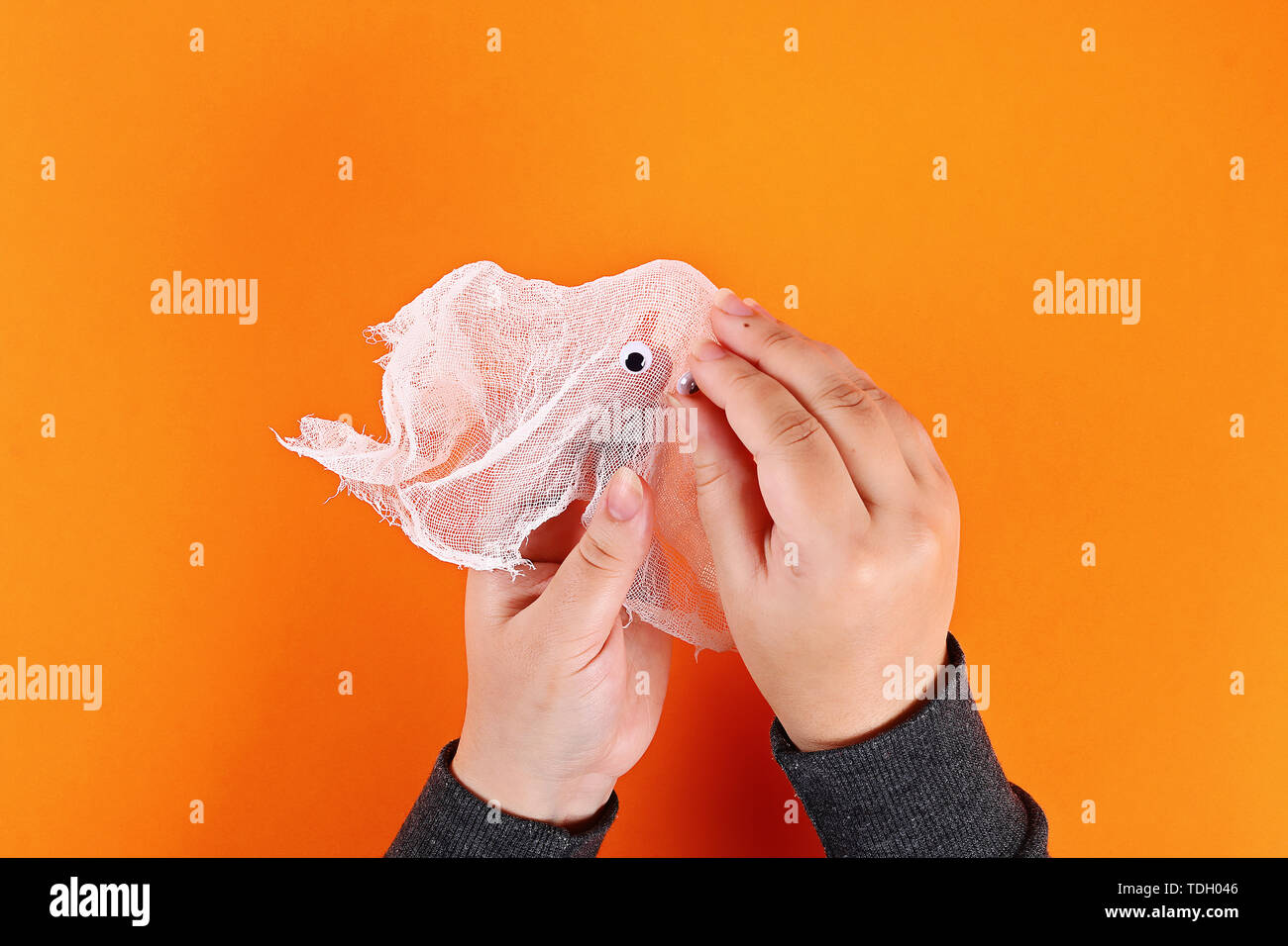 11 Diy Halloween ghost of starch and gauze on orange background. Gift ...