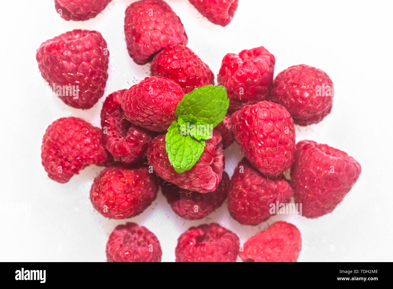 Fresh raspberries on white background Stock Photo - Alamy