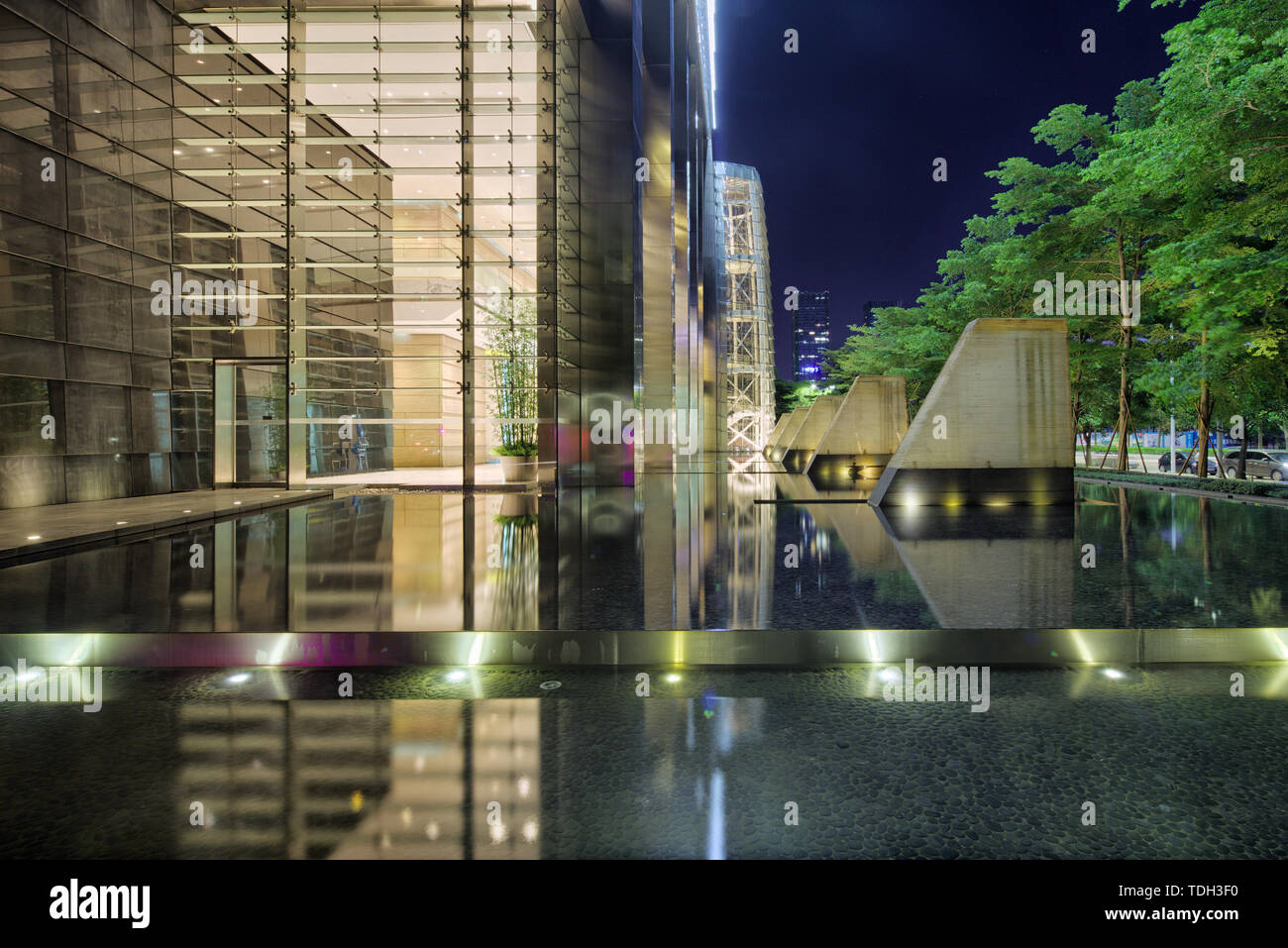 Illuminated building exterior and footpath Stock Photo - Alamy