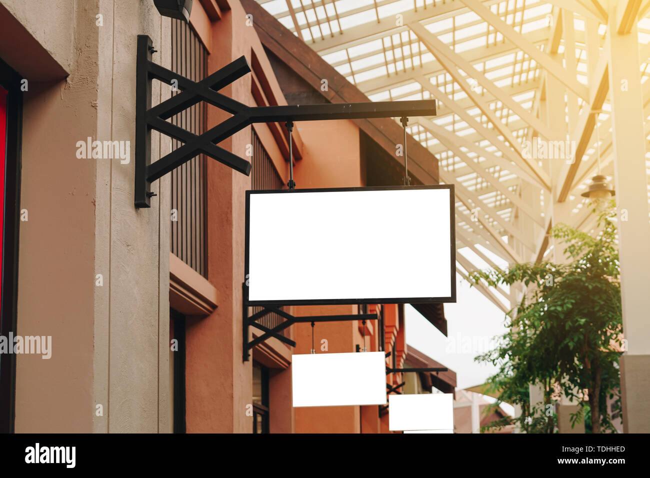 Empty signage and blank mock up hanging on street with copy space Stock ...