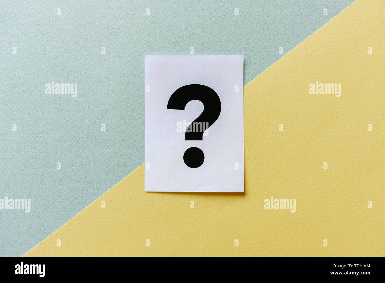 Question mark printed on a page of white paper placed to the center on ...