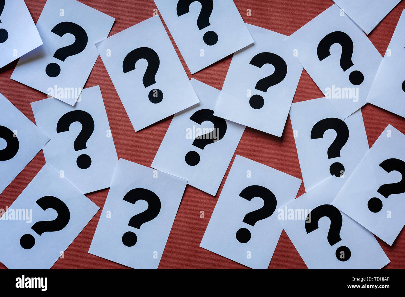 Background pattern of printed question marks on white cards scattered ...
