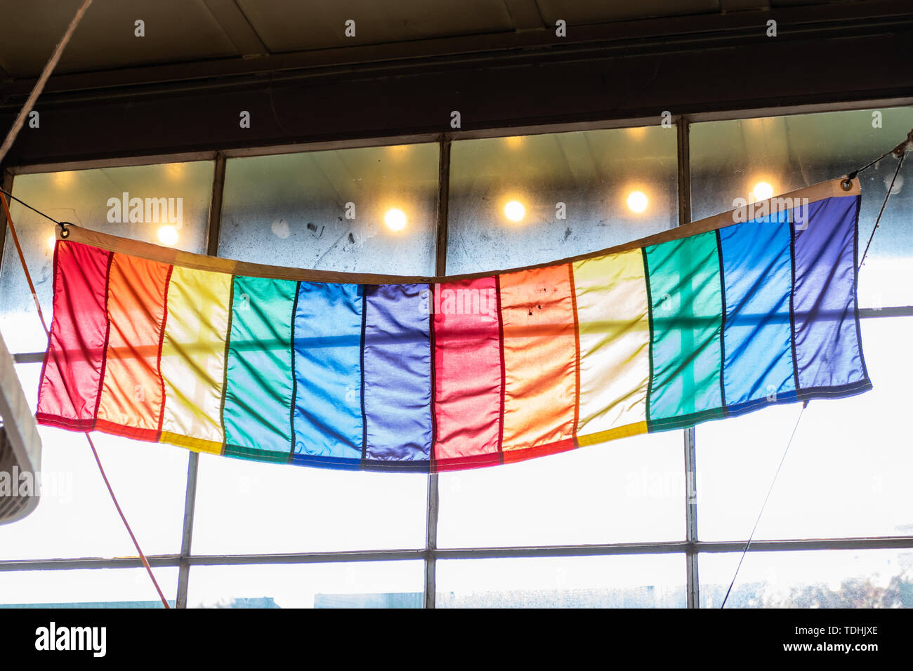 Rainbow Flag Against Window Stock Photo - Alamy