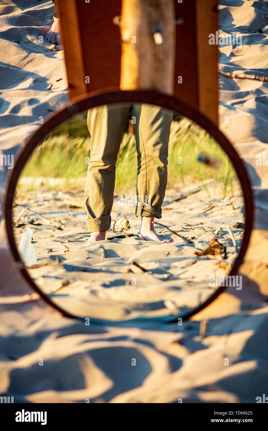 human feet standing on the sand or ground soil in nature textured ...