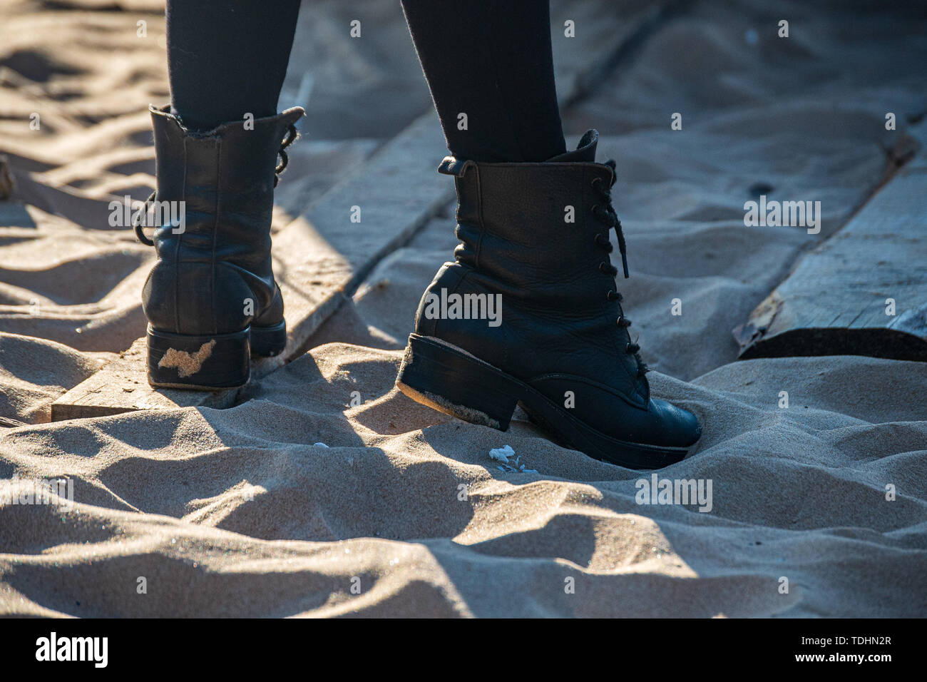 human feet standing on the sand or ground soil in nature textured ...