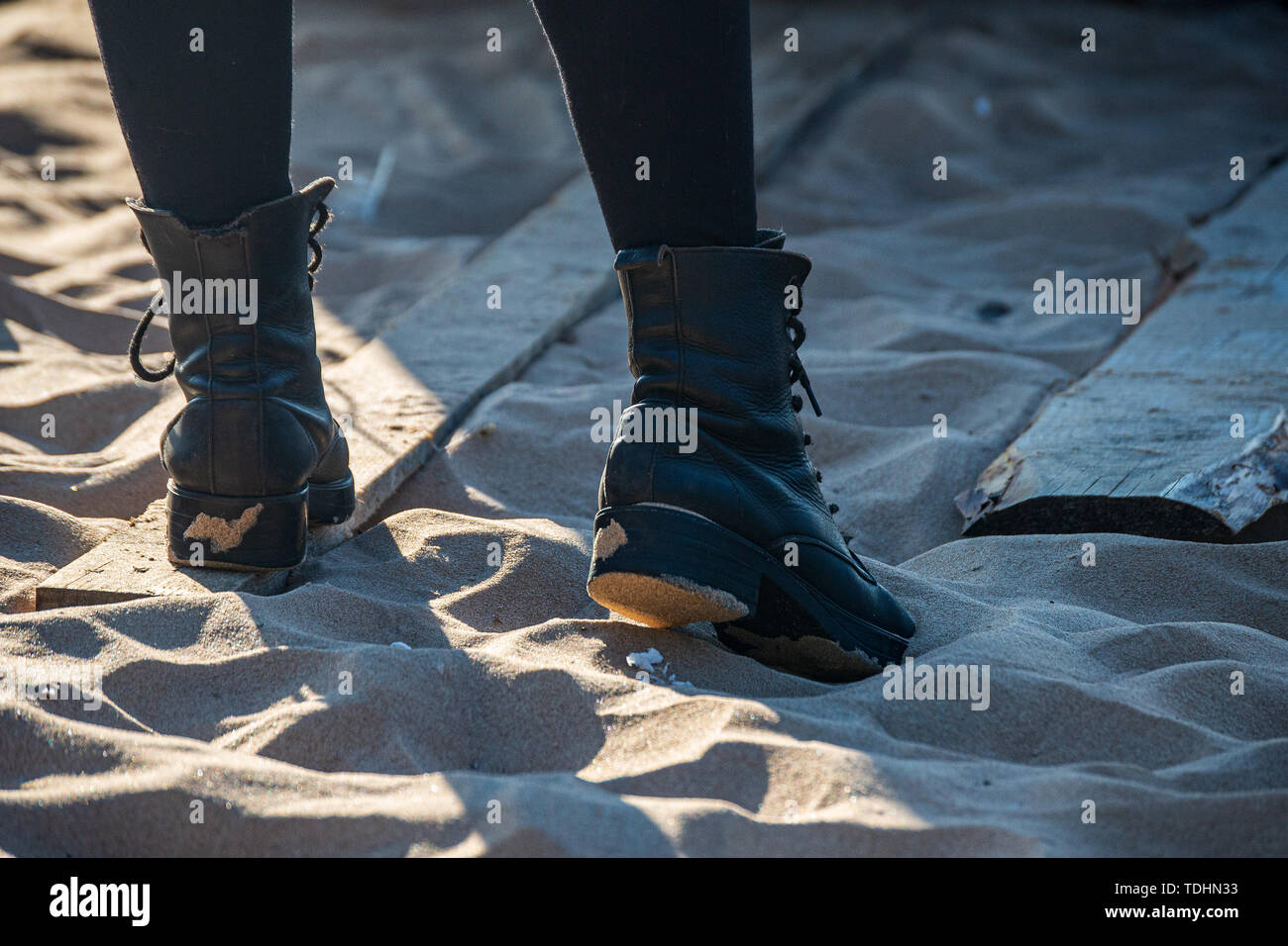 human feet standing on the sand or ground soil in nature textured ...