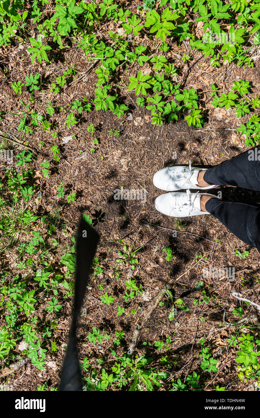 human feet standing on the sand or ground soil in nature textured ...