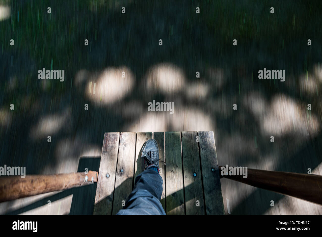 human feet with shoe standing on wooden planks in nature Stock Photo ...