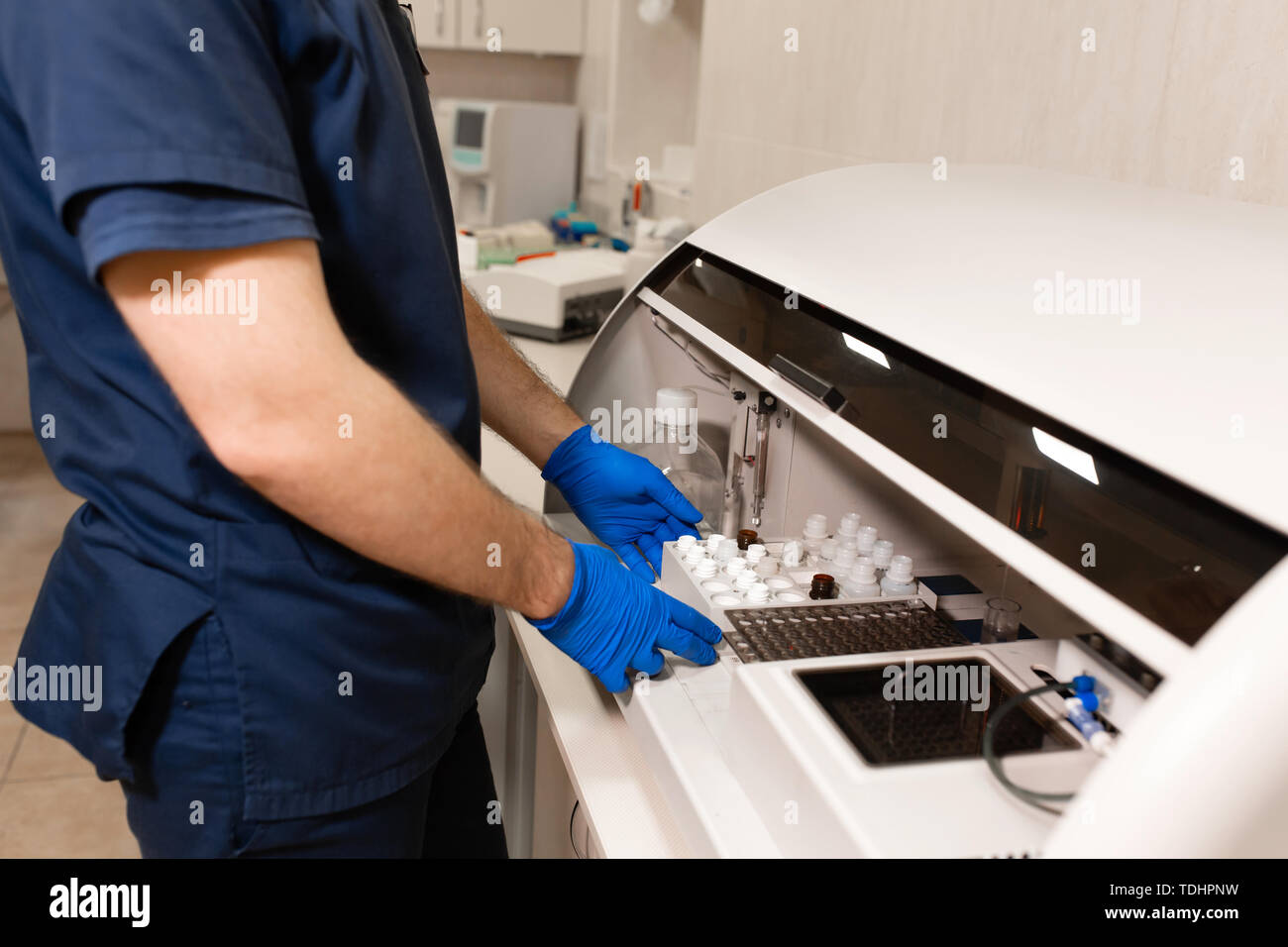 Laboratory assistant make test blood in automatical blood sample ...