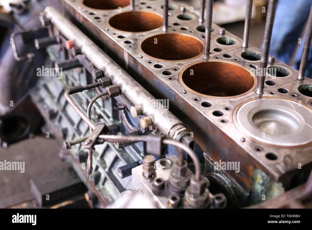 Mechanic repairs old motor of truck in a car repair station ...