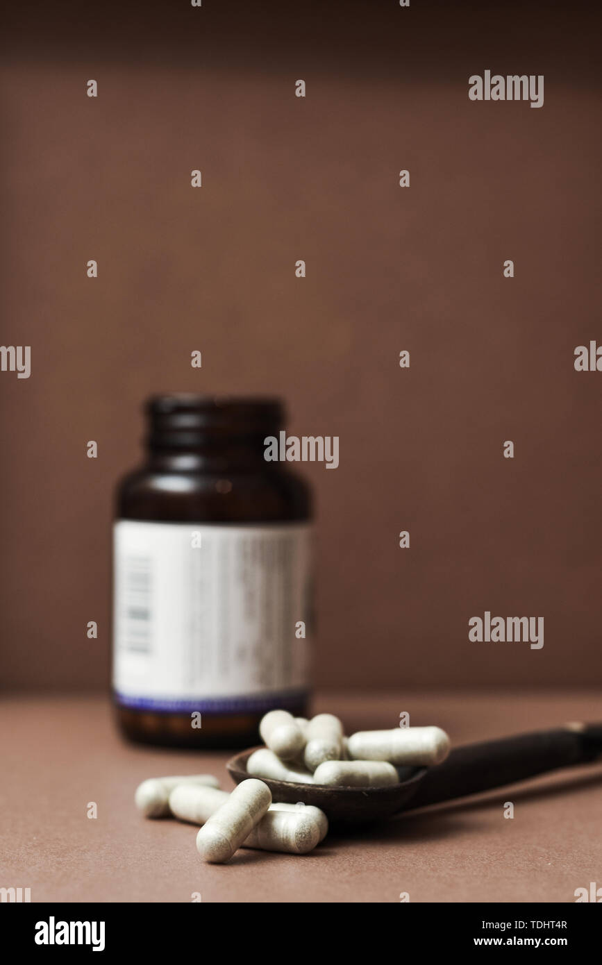 Vitamins in a bottle. Health supplement tablets with natural healing ...