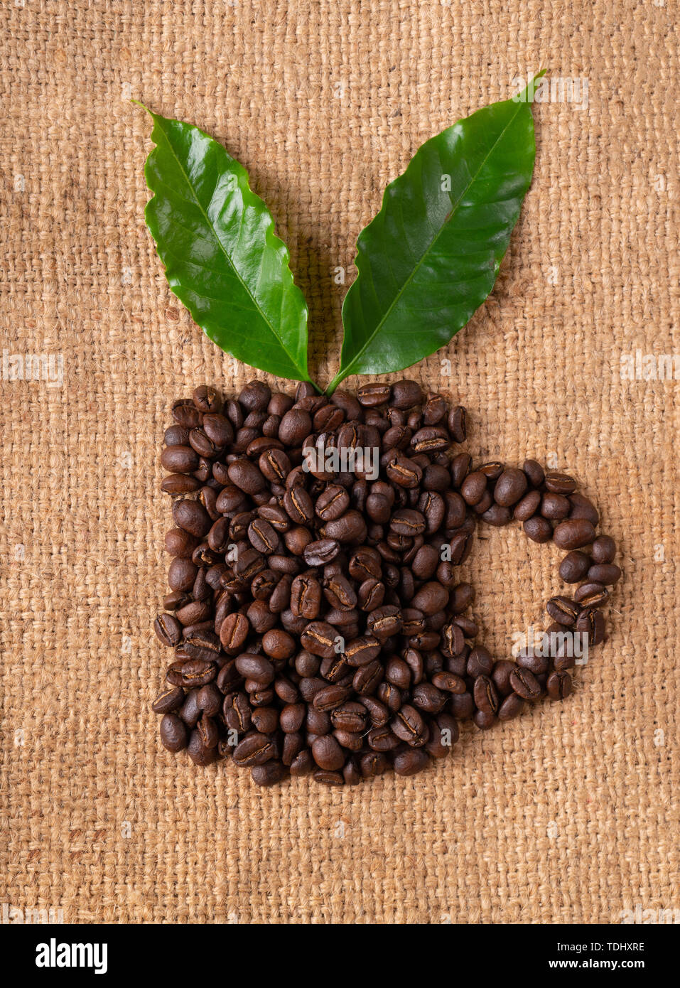 roasted coffee bean with leave on linin sack Stock Photo - Alamy