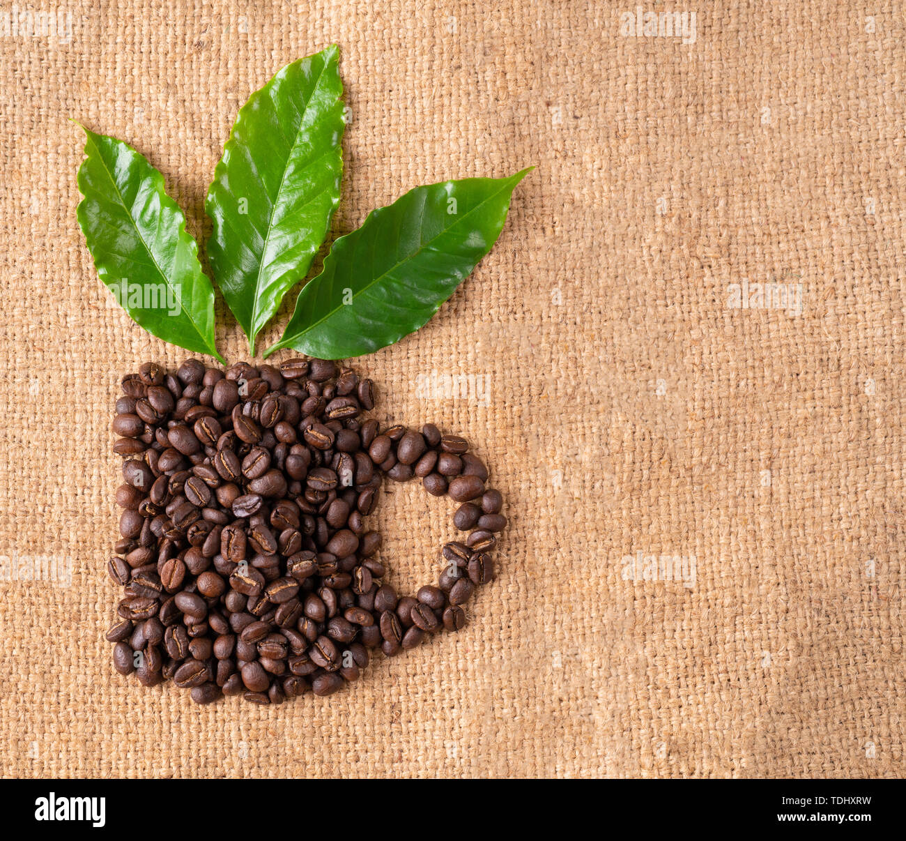 roasted coffee bean with leave on linin sack Stock Photo - Alamy