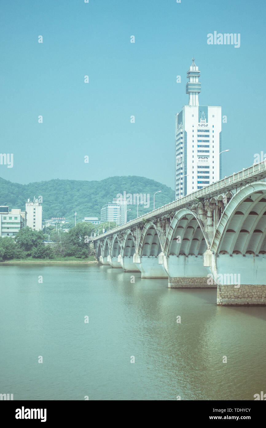 Arched Cross-River Bridge in Orange Island Stock Photo - Alamy