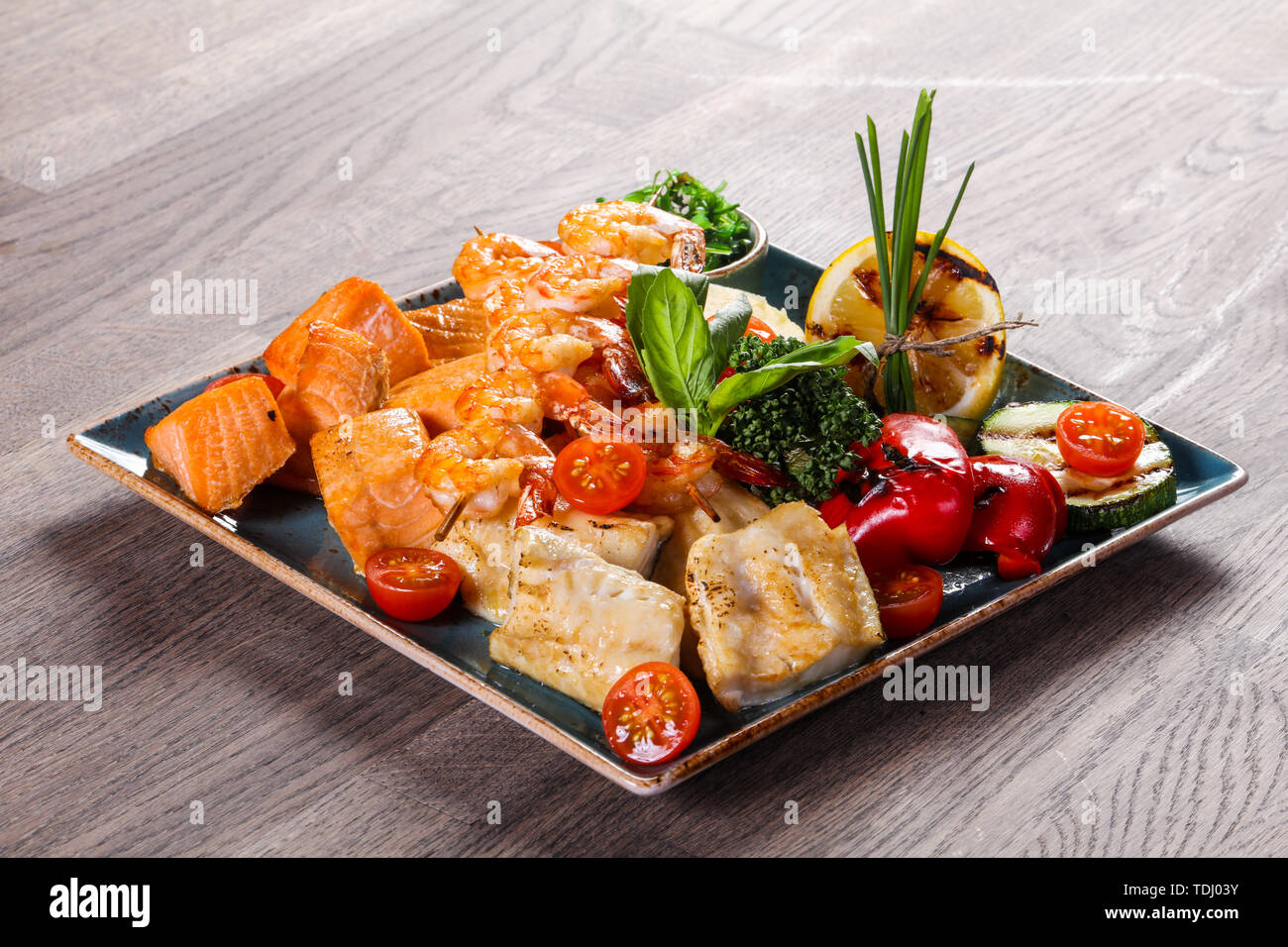 Fish and prawn plate served grilled vegetables Stock Photo - Alamy