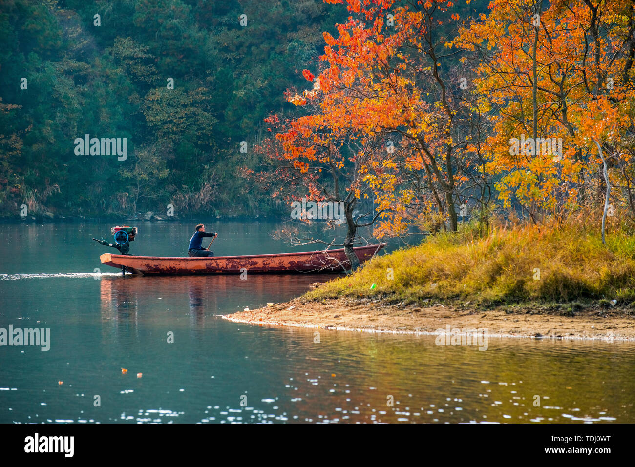 A slow boat in the lake Stock Photo - Alamy