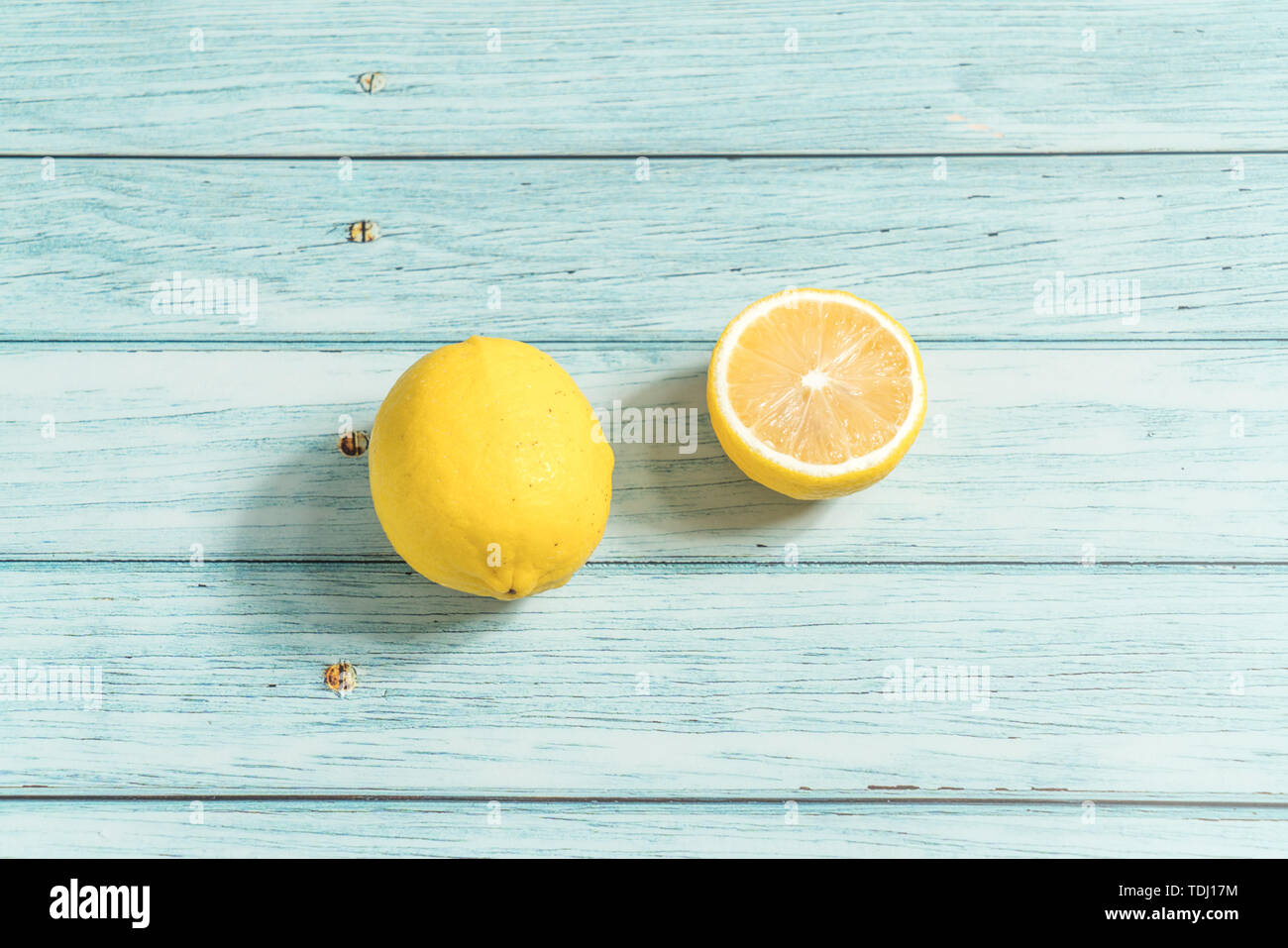 Lemon with teal wood pattern background Stock Photo - Alamy