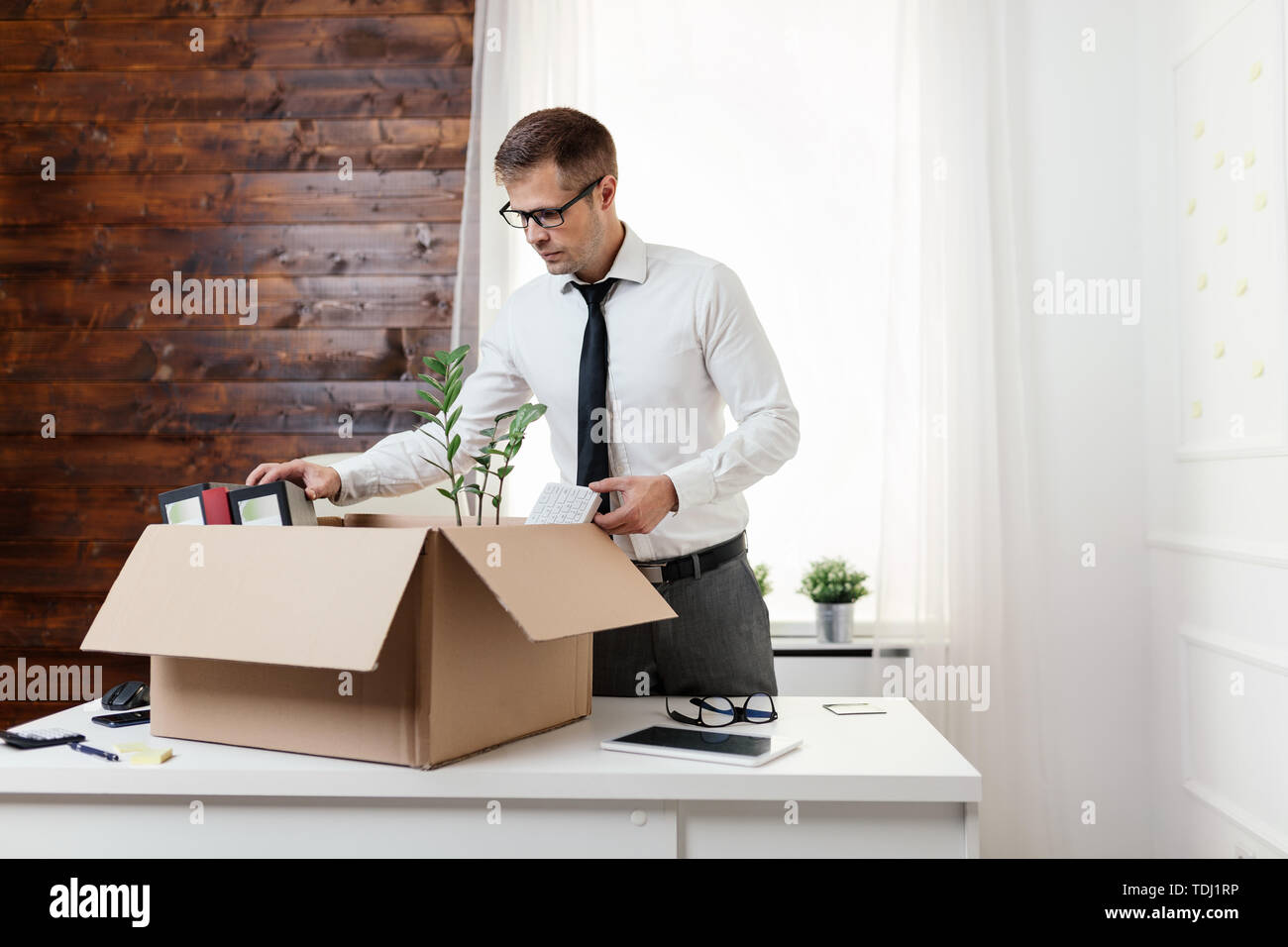 Successful businessman moving into a new office Stock Photo - Alamy