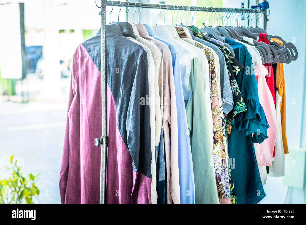 Summer wardrobe showcase. White and gray tone knitwear hanging on a ...