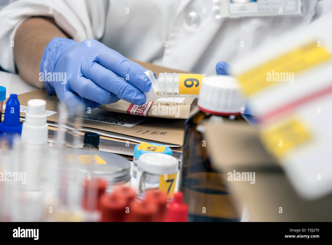 Scientific Police hold evidence of a crime in scientific lab ...