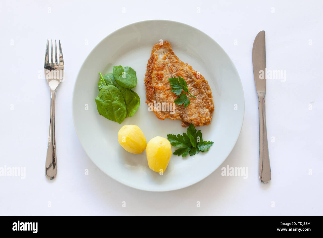 Fried fish fillet from the flatfish flounder with potatoes, spinach and ...