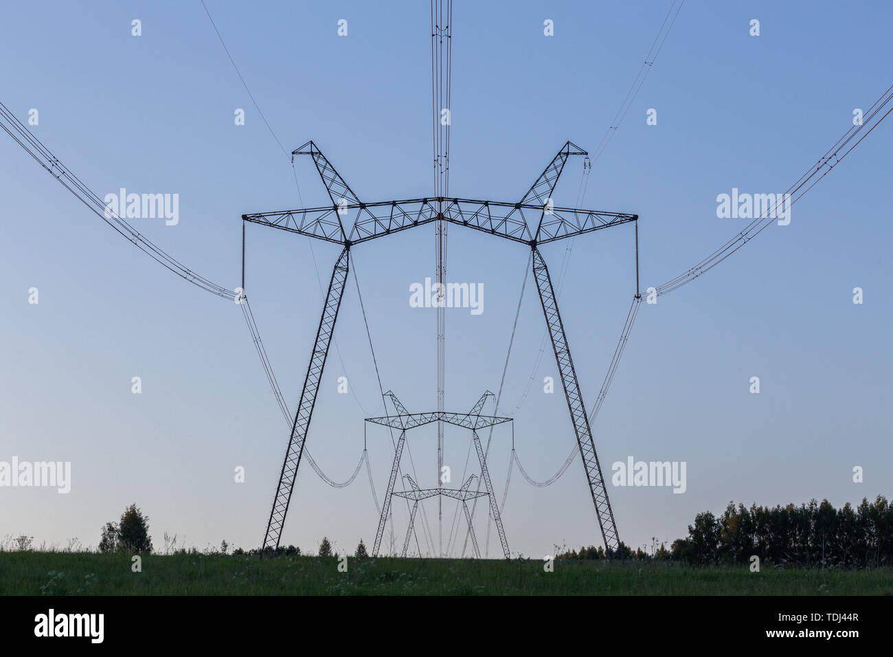 huge power line towers on field at summer evening Stock Photo - Alamy