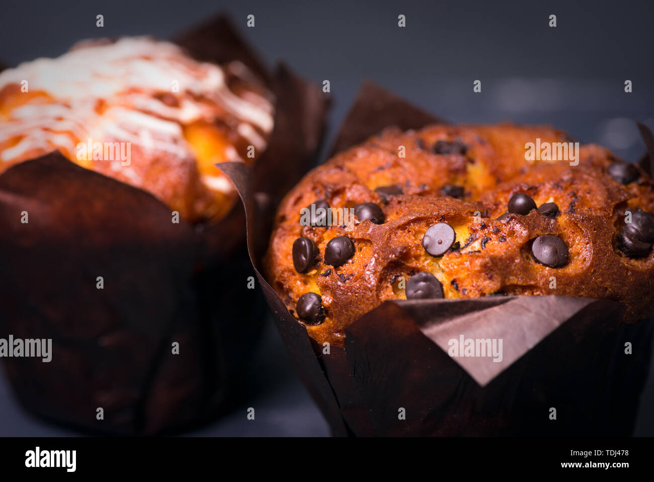 Close up. Dark key. Muffins with chocolate pieces in black paper Stock ...