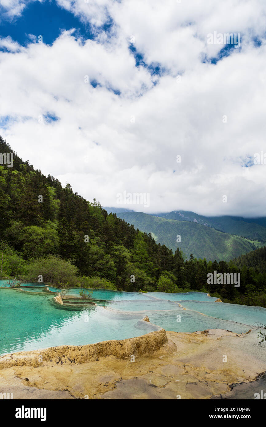 Majestic trees and tall landforms and terrain and daylight landmarks hi ...