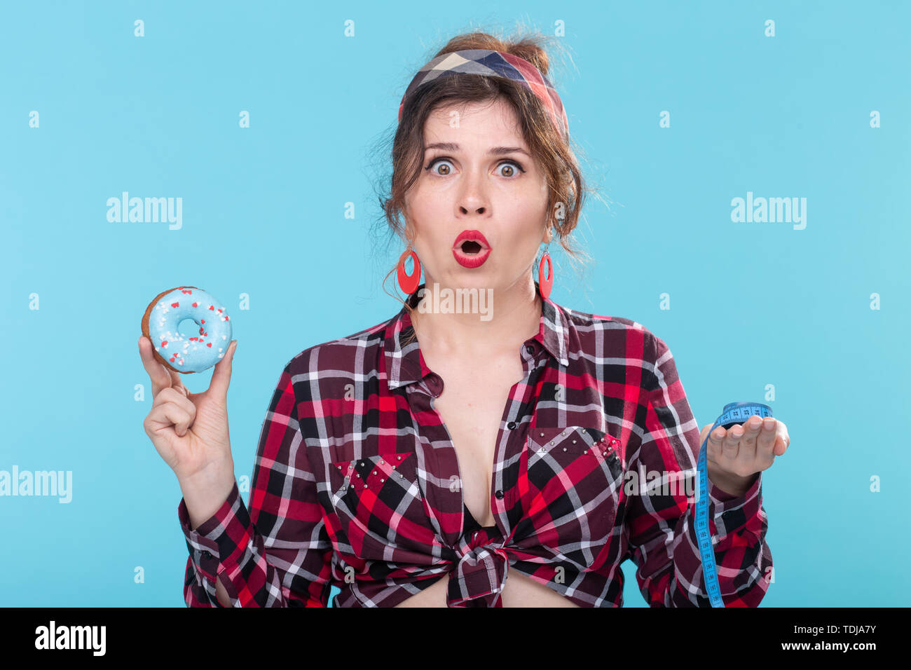 Diet, weight loss and junk food - pin-up woman choosing between dessert ...