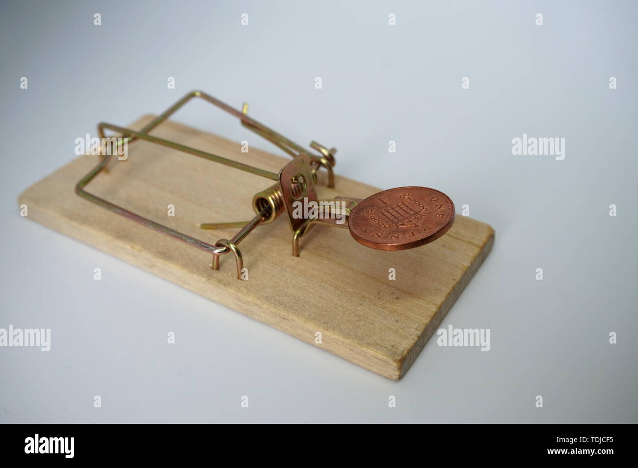 Mouse trap with a penny as bait Stock Photo - Alamy