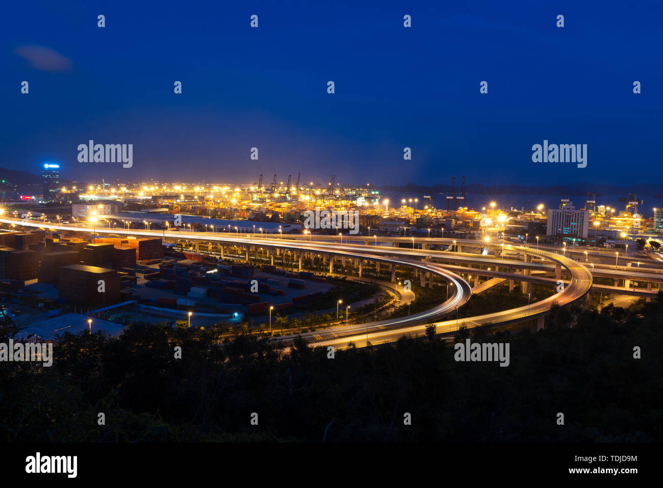 Illuminated and elevated expressway and cityscape at night Stock Photo ...