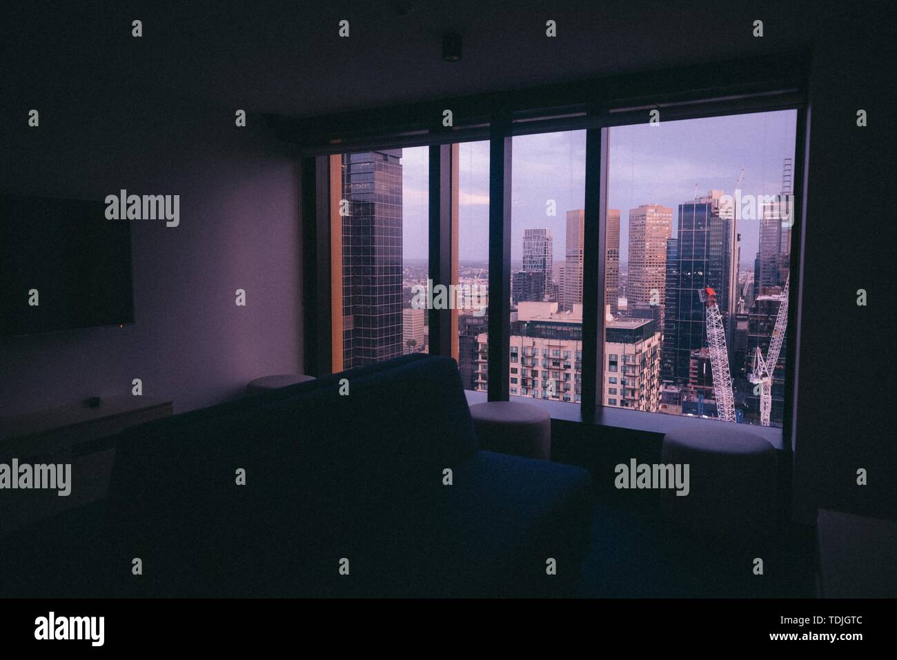 Small apartment with a large window with a view of an urban city ...