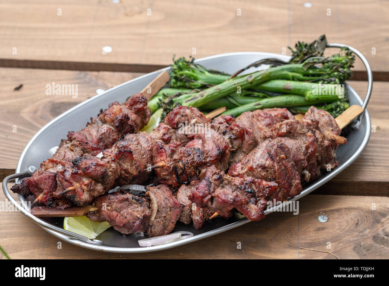 Grilled lamb meat kebabs with green broccolini Stock Photo - Alamy