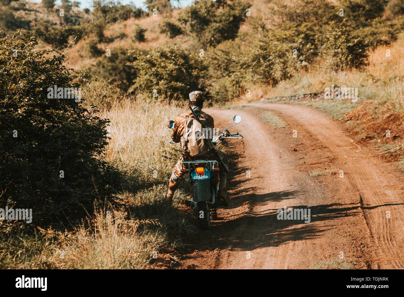 Anti Poaching guard on a motorcycle, on a dirt road Stock Photo - Alamy