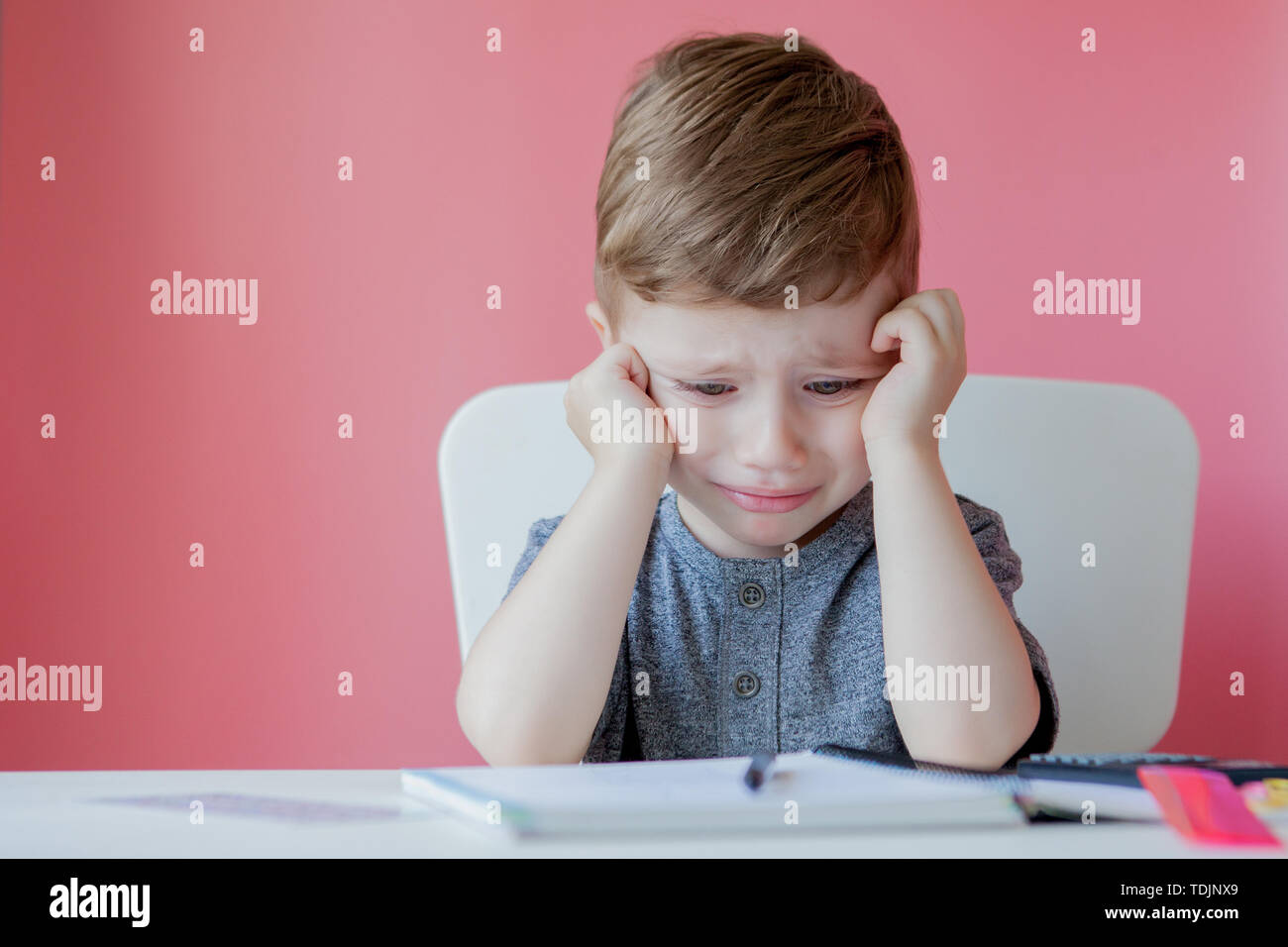 Portrait of cute kid boy at home making homework. Little concentrated ...