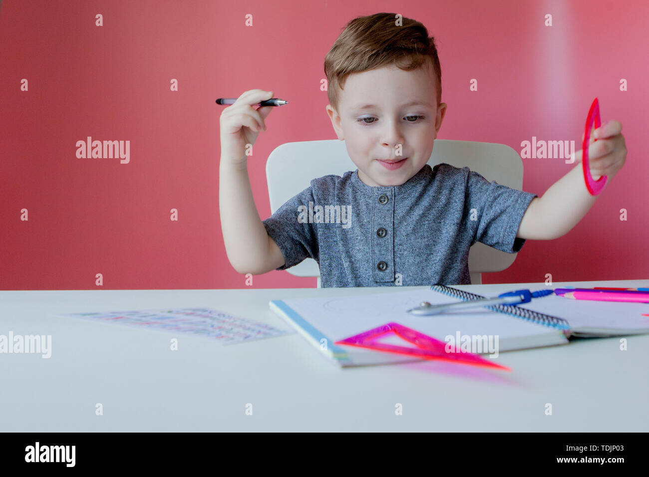 Portrait of cute kid boy at home making homework. Little concentrated ...
